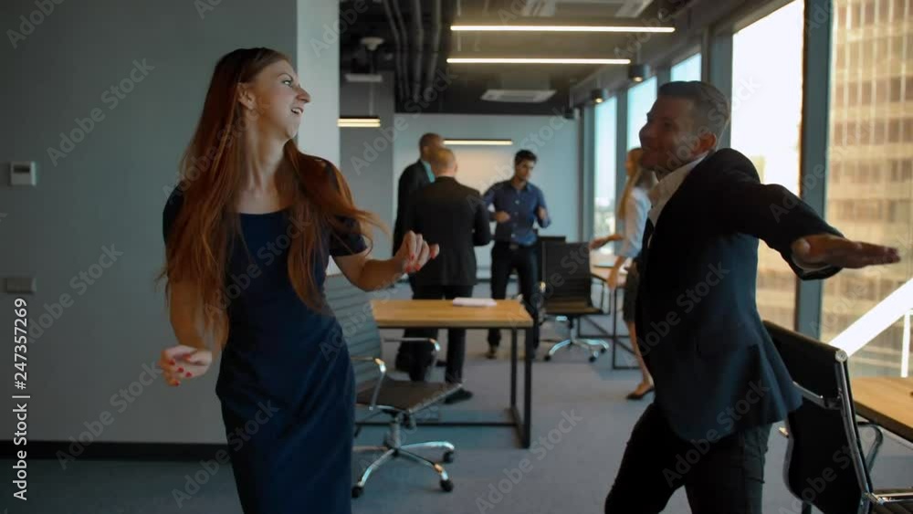 Couple in business office dancing after winning deal celebrating. Two ...