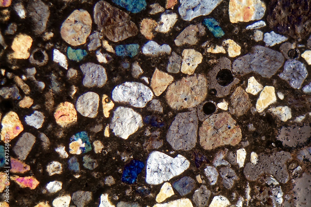 Thin section of concrete under a microscope and in cross polarized ...