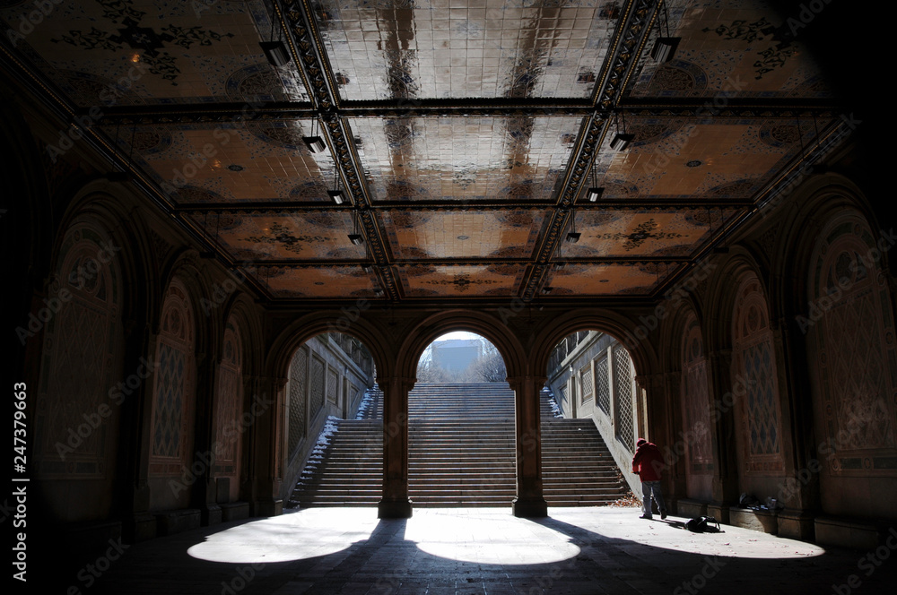 A long grand staircase leads to an underground arcade with columns ...