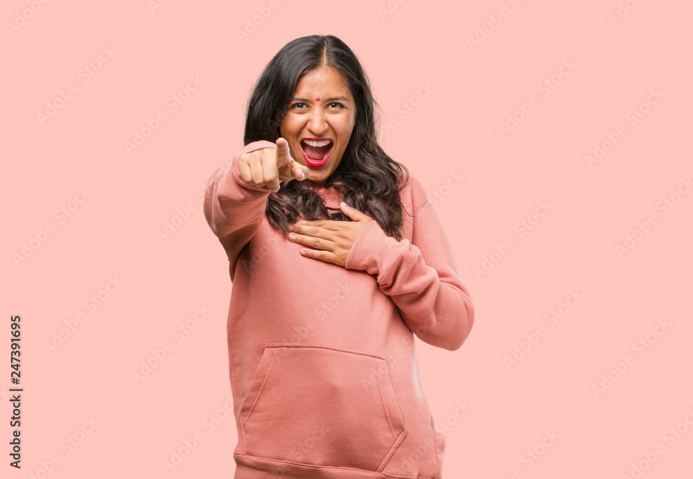 Portrait of fitness young indian woman shouting, laughing and making ...