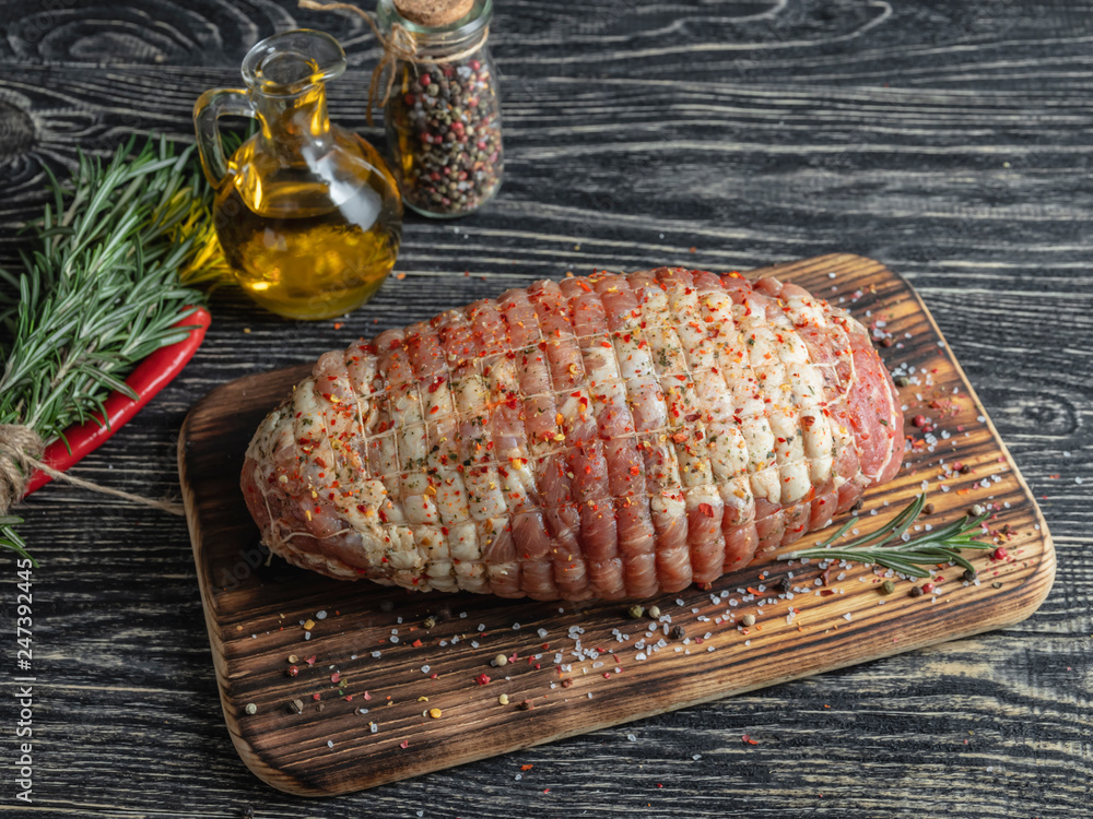 Raw pork roulade. Raw rolled meat enclosed in tied netting. Meat pulp ...