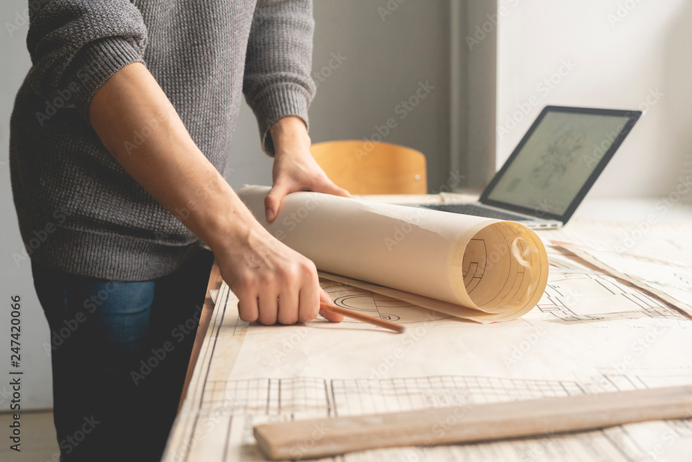 persosn hand roll paper scheme or drawing b Stock Photo | Adobe Stock