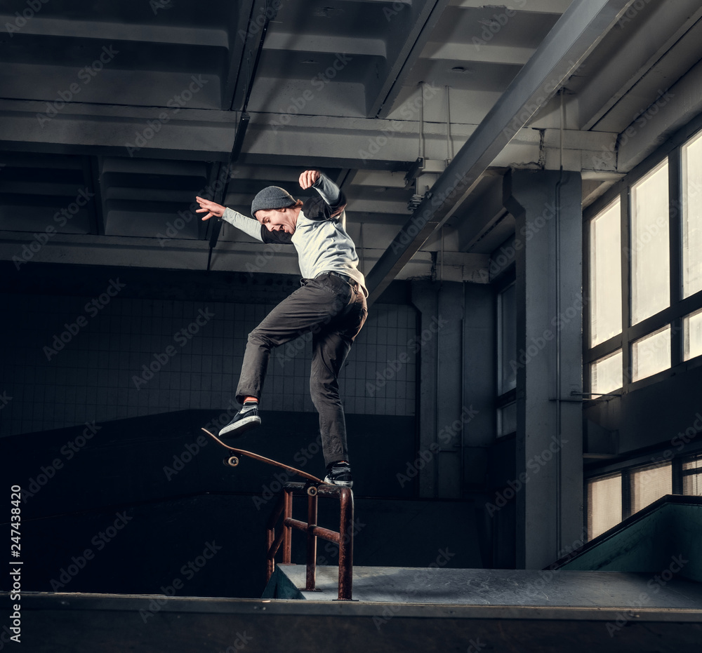 Skateboarder performing a trick on mini ramp at skate park indoor ...