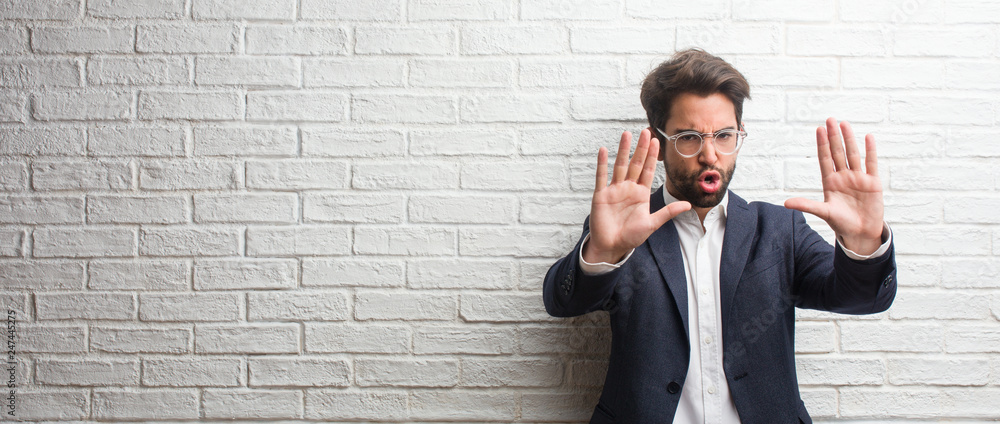 Young friendly business man serious and determined, putting hand in ...