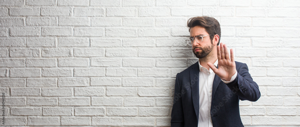 Young friendly business man serious and determined, putting hand in ...