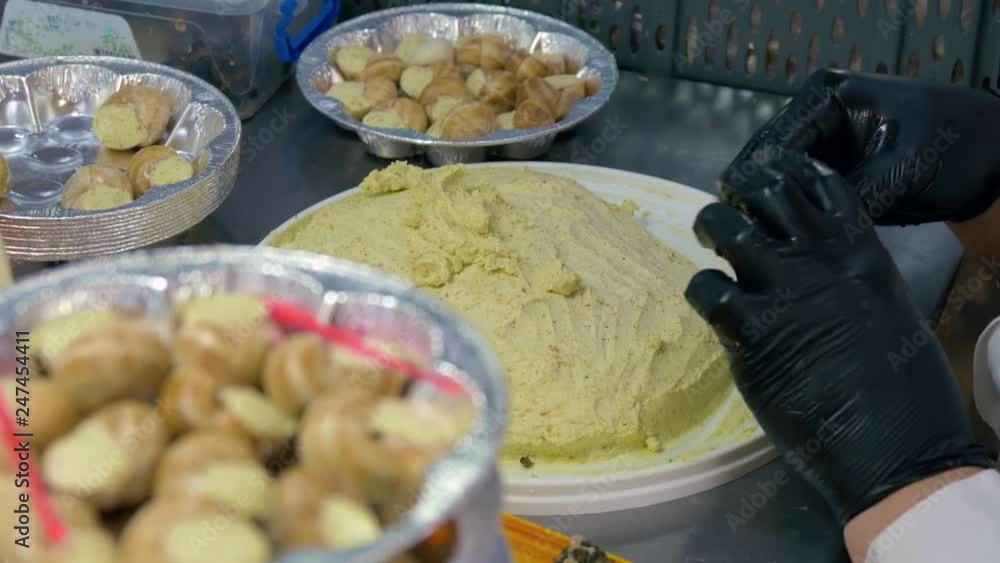 Snail Farm. Cooking Escargot. Workers Stuffed Snail Shells with Garlic ...