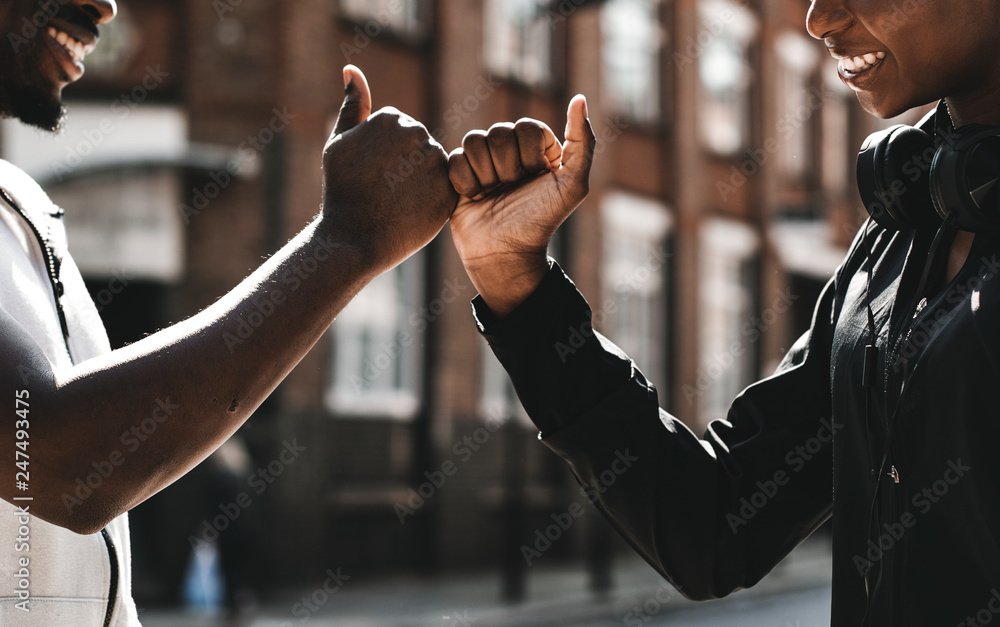 Friends greeting with a signature handshake Stock Photo | Adobe Stock