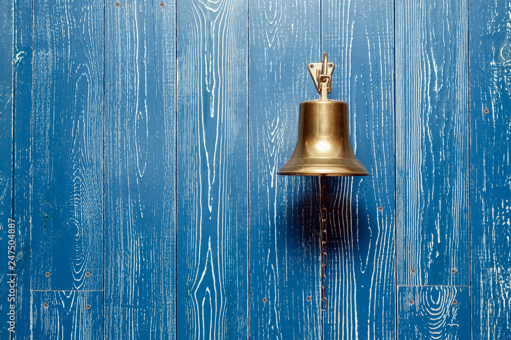Copper old vintage bell, doorbell, rope on a wooden blue aged wall ...