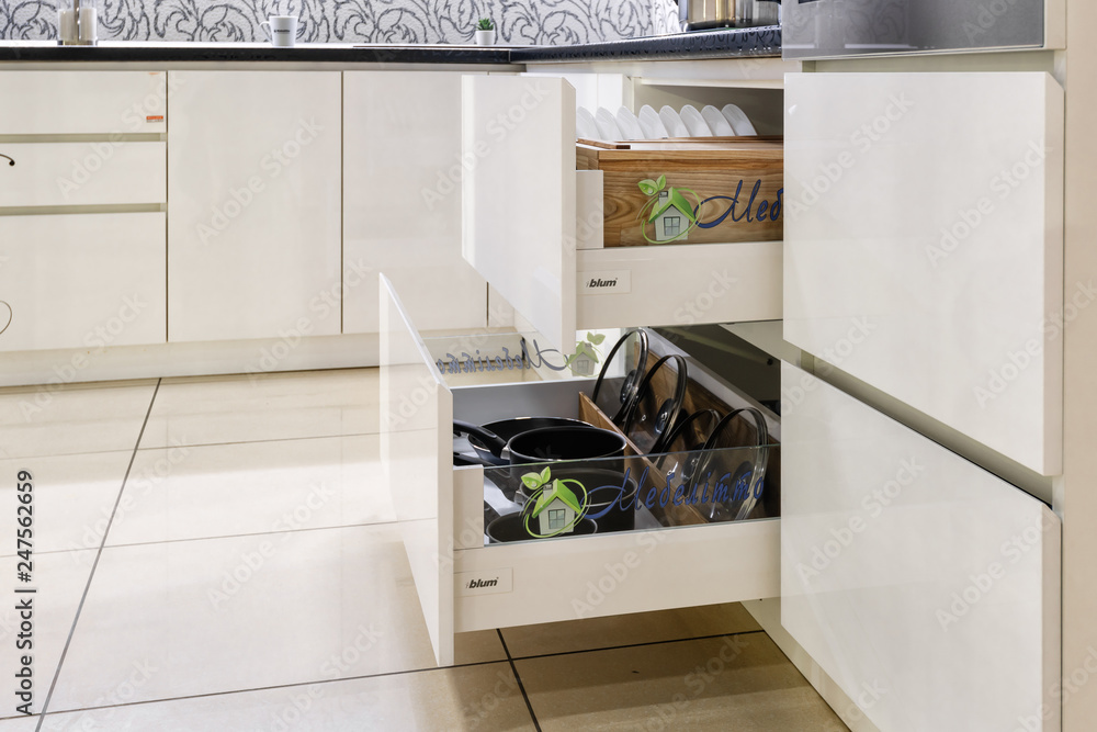 Opened kitchen drawer, kitchen in a traditional style with wooden white ...