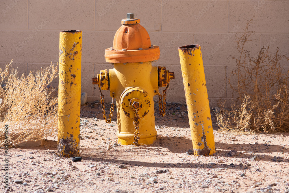 Fire hydrant and protection poles in front of a block wall Photos ...