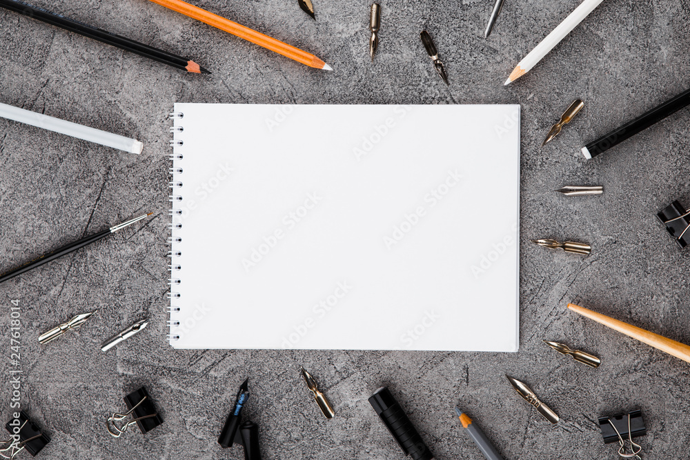 Artist home office desk workspace frame paint brushes and tools on gray ...