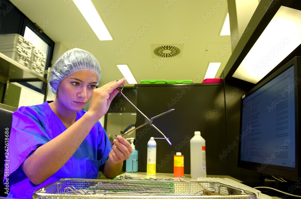 A young woman works in a hospital as a medical hygiene technician. She ...