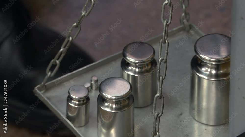 Calibration weights for scales. On the scales are weights of different ...
