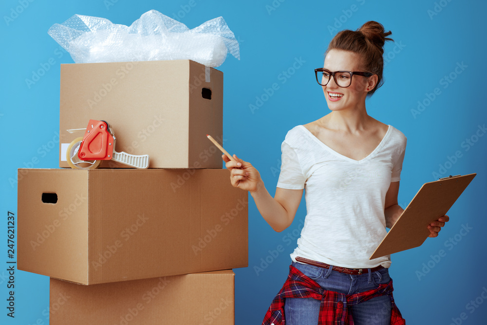 woman near cardboard box using moving checklist and count boxes Stock ...