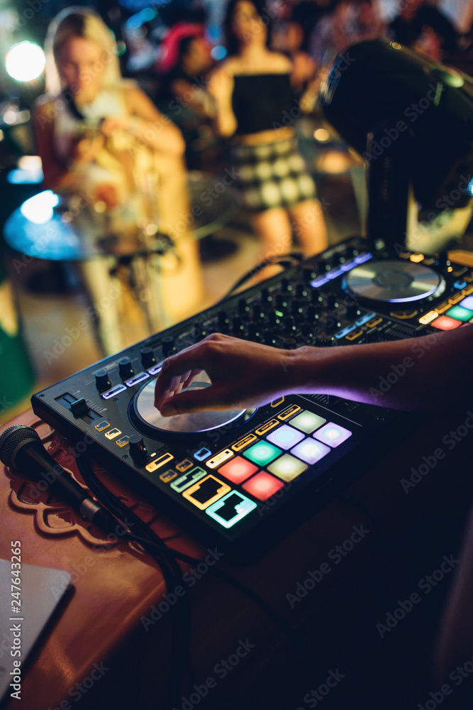Foto de DJ plays live set and mixing music on turntable console at ...