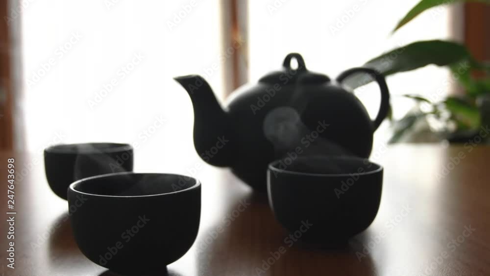 minimal background of a green japanese tea set with steam coming out of ...