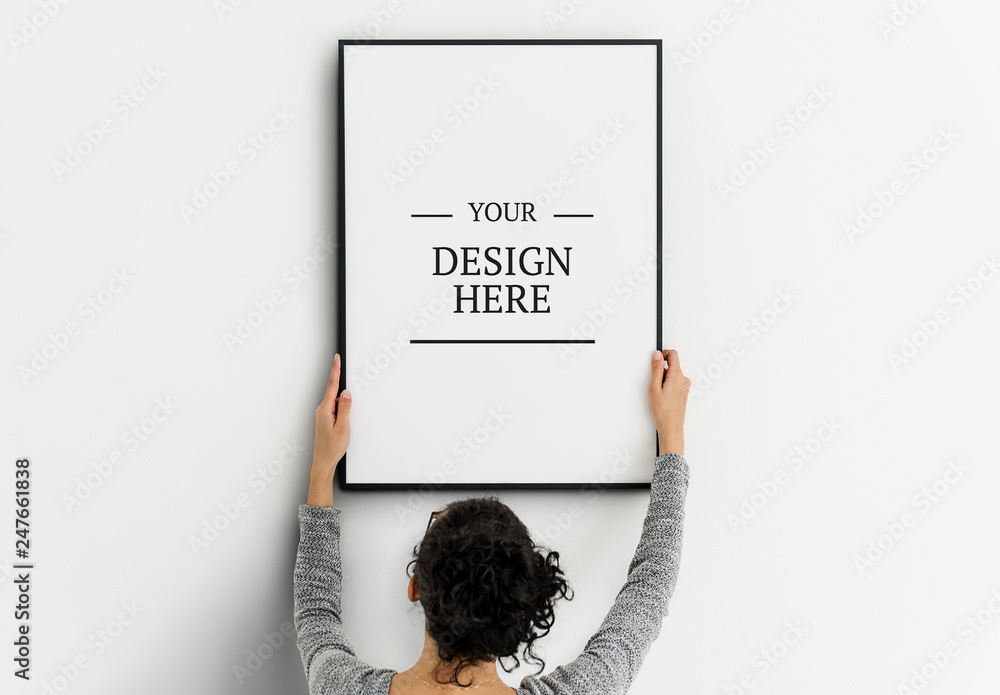 Person Hanging Frame on Wall Mockup Stock Template | Adobe Stock