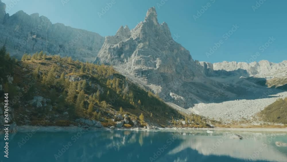Panning point of interest grey rocky cliff faces covered in green ...