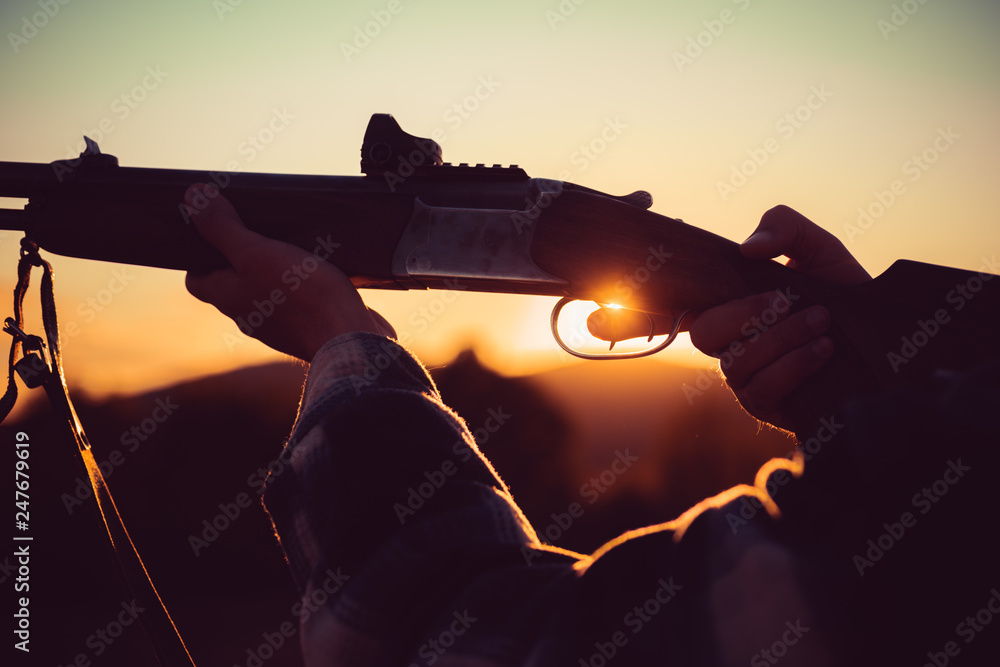Rifle Hunter Silhouetted in Beautiful Sunset. Hunter with Powerful ...