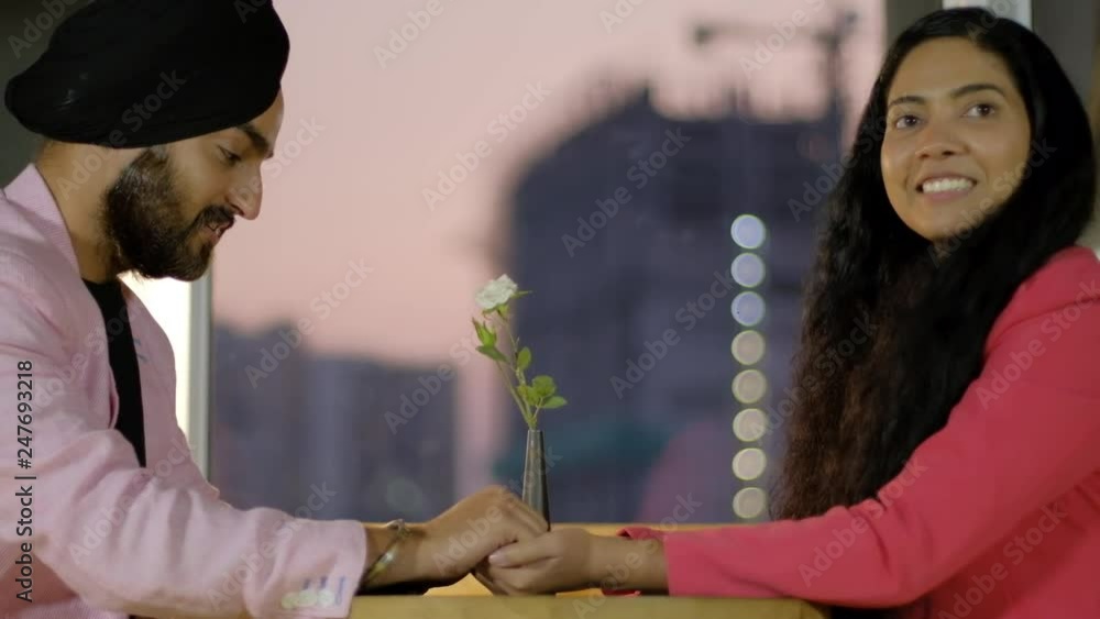 Beautiful Indian couple, turbaned Sikh and curly woman, hold hands ...