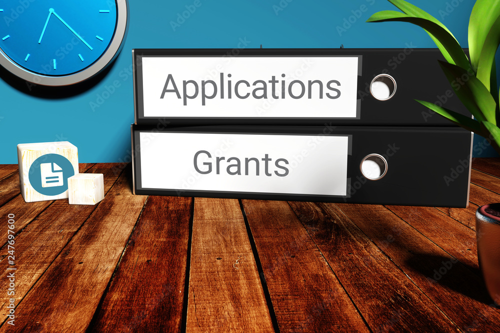 Funding. File folder labeled with the terms Applications and grants ...