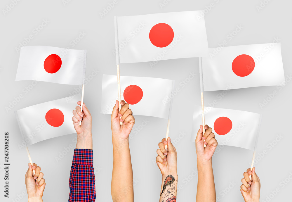 Hands waving the flags of Japan Stock Photo | Adobe Stock