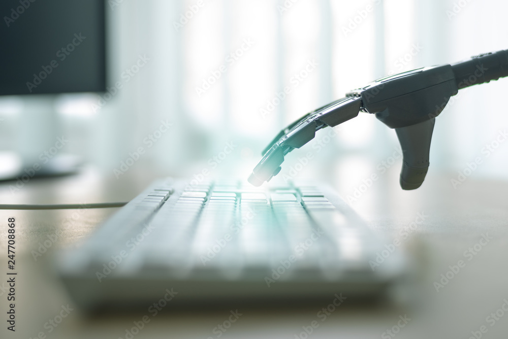 Robot with artificial intelligence is working on a computer. Robotic ...