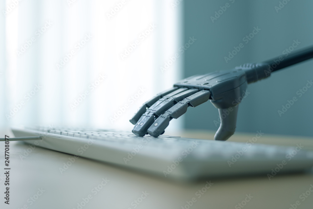 Robot with artificial intelligence is working on a computer. Robotic ...