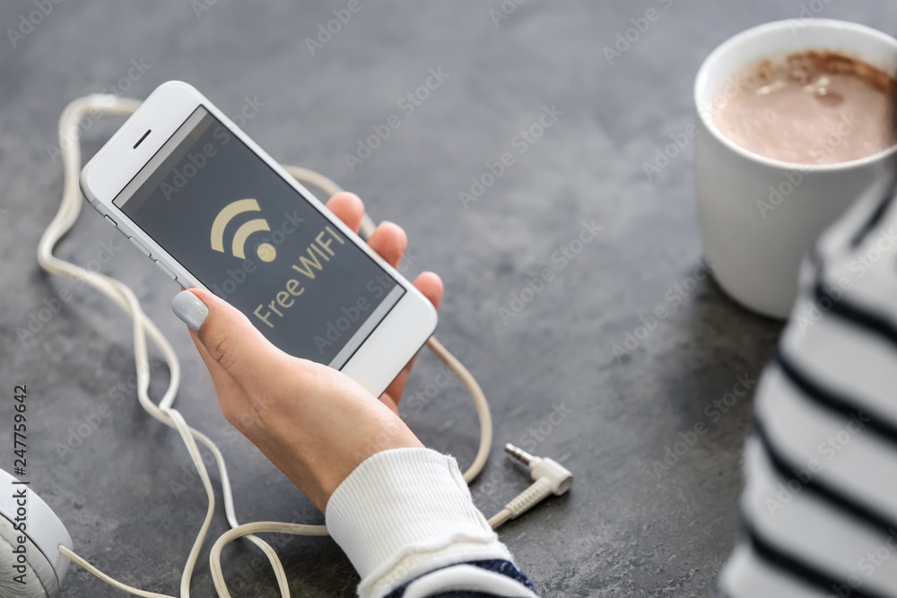 Young woman with mobile phone using wifi in cafe, closeup Stock Photo ...