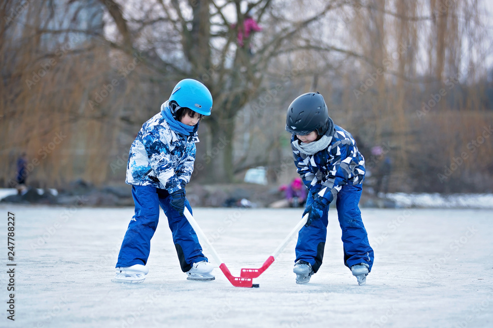 Children, boys, friends and brothers playing hockey and skating in the ...