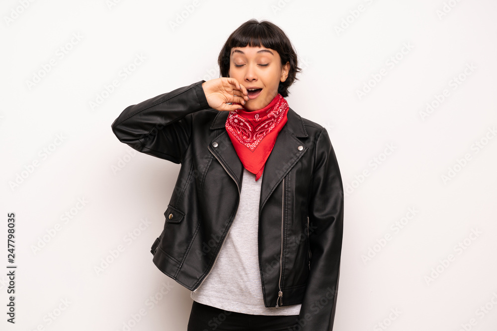 Woman with leather jacket and handkerchief yawning and covering wide ...
