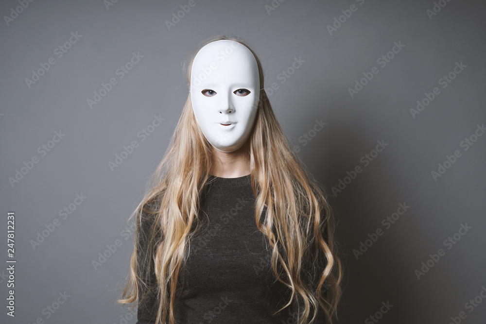 mysterious woman hiding face and identity behind plain white mask ...