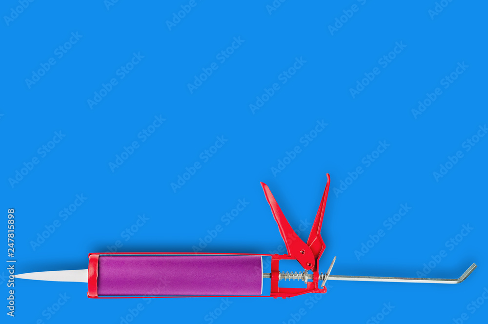 One red metal gun for plastic tube with silicone or glue or other ...