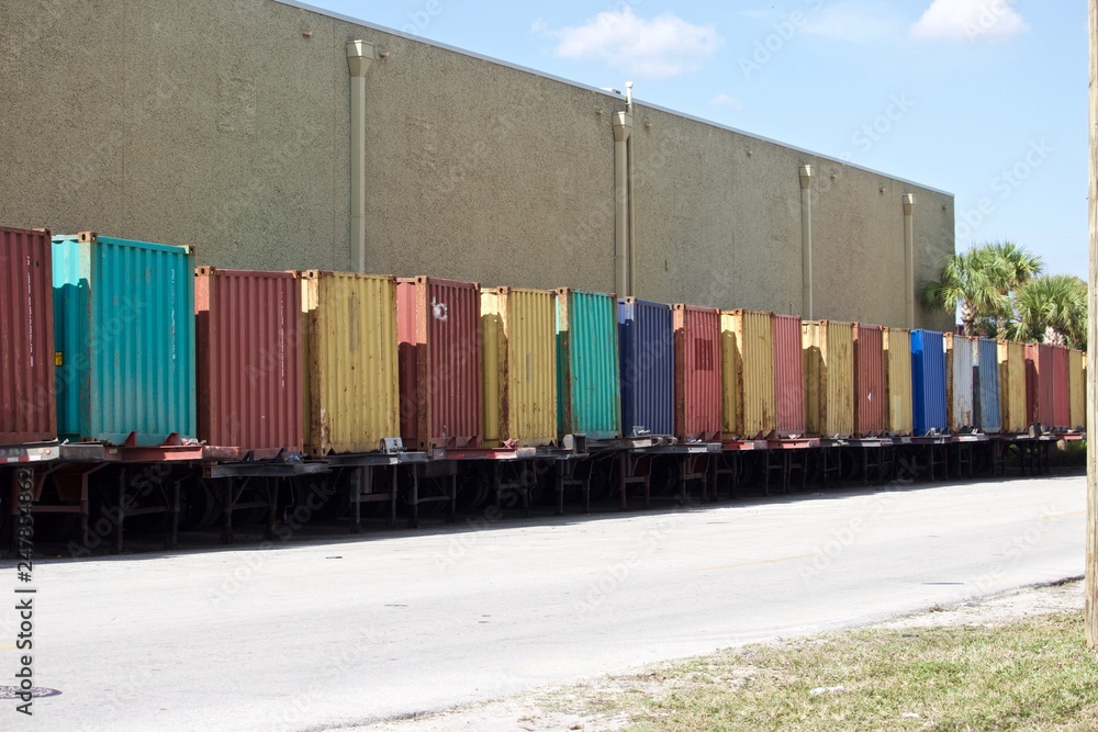 Shipping containers on trailers, colorful row of shipping containers ...