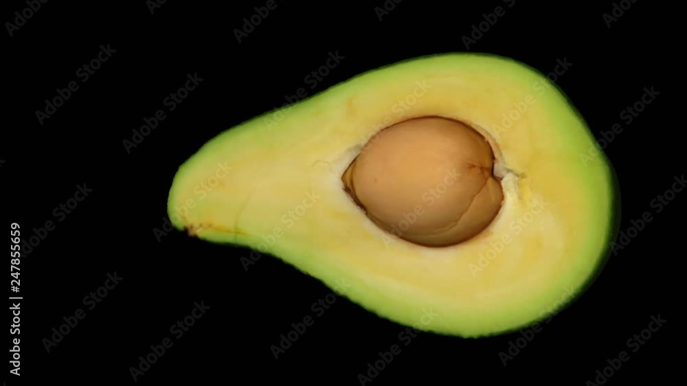 Realistic render of a rotating green Florida avocado (cut in half with ...