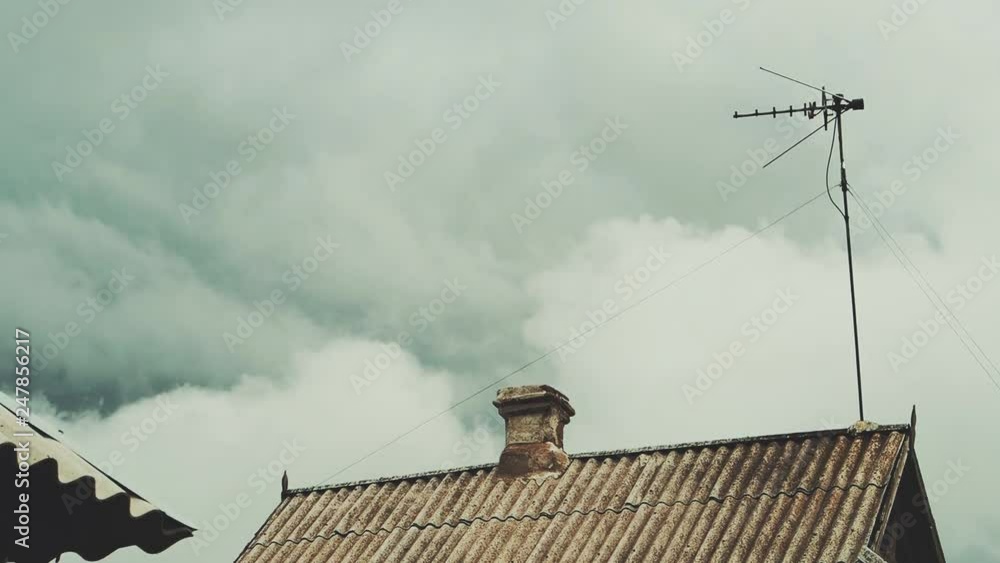 Over the rooftop clouds float. Magnificent clouds clouded the sky. On ...