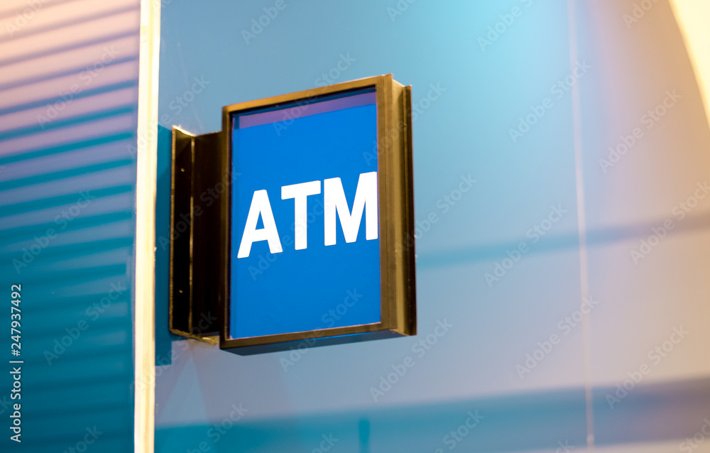 Modern square shape ATM sign in department store. White text on blue ...