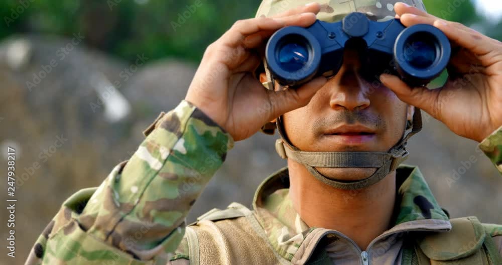Front view of young caucasian military soldier observing on field ...
