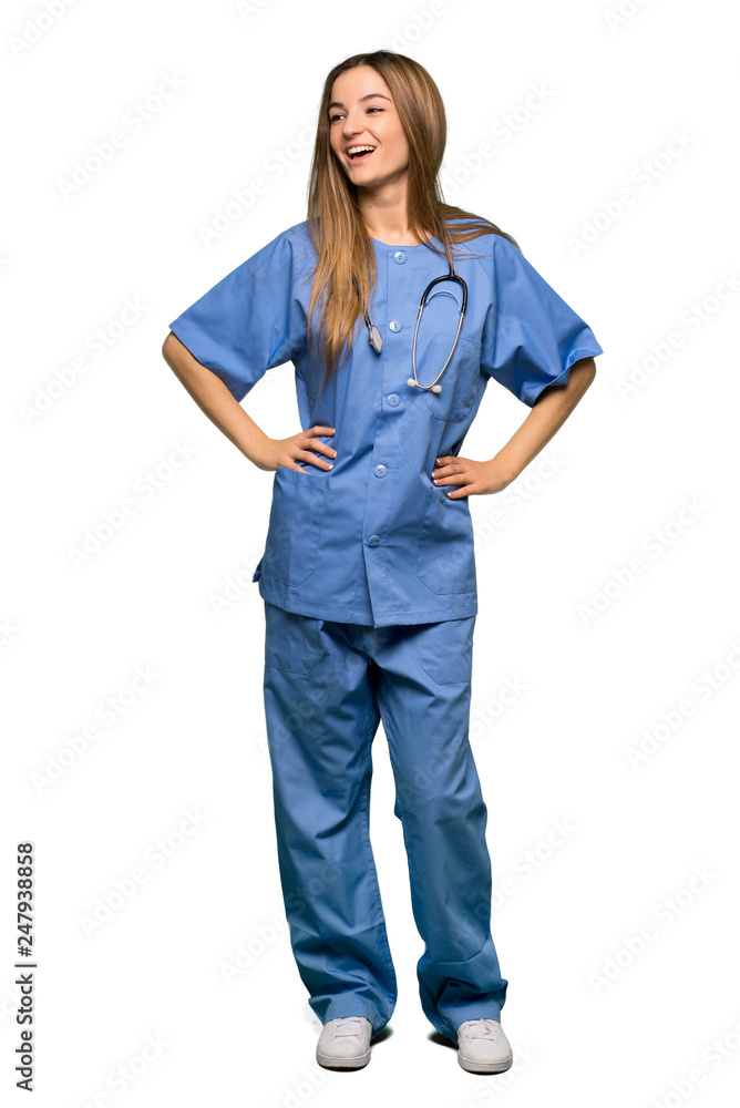 Full body Young nurse posing with arms at hip and laughing on isolated ...