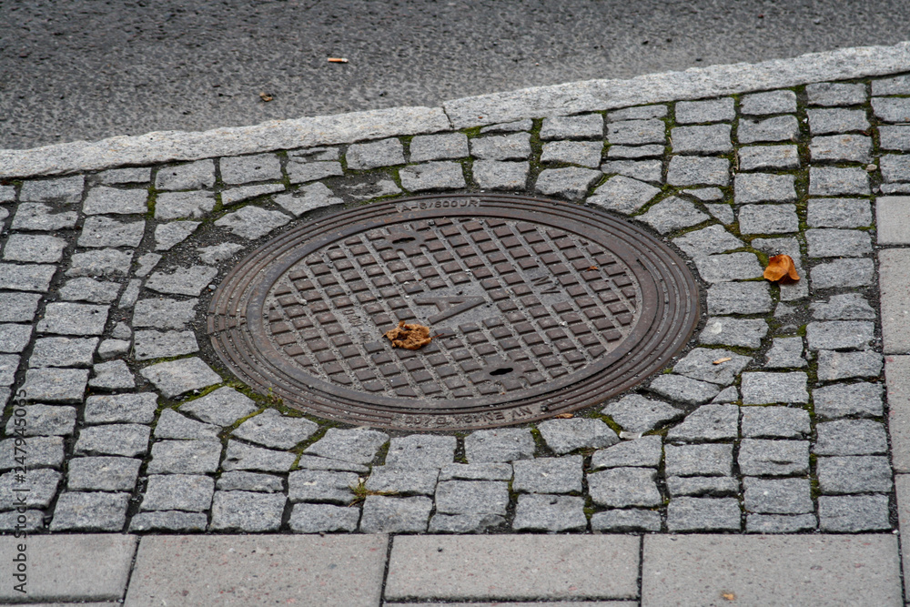 Scandinavian manhole in its urban surrounding. Hidden beauty in design ...