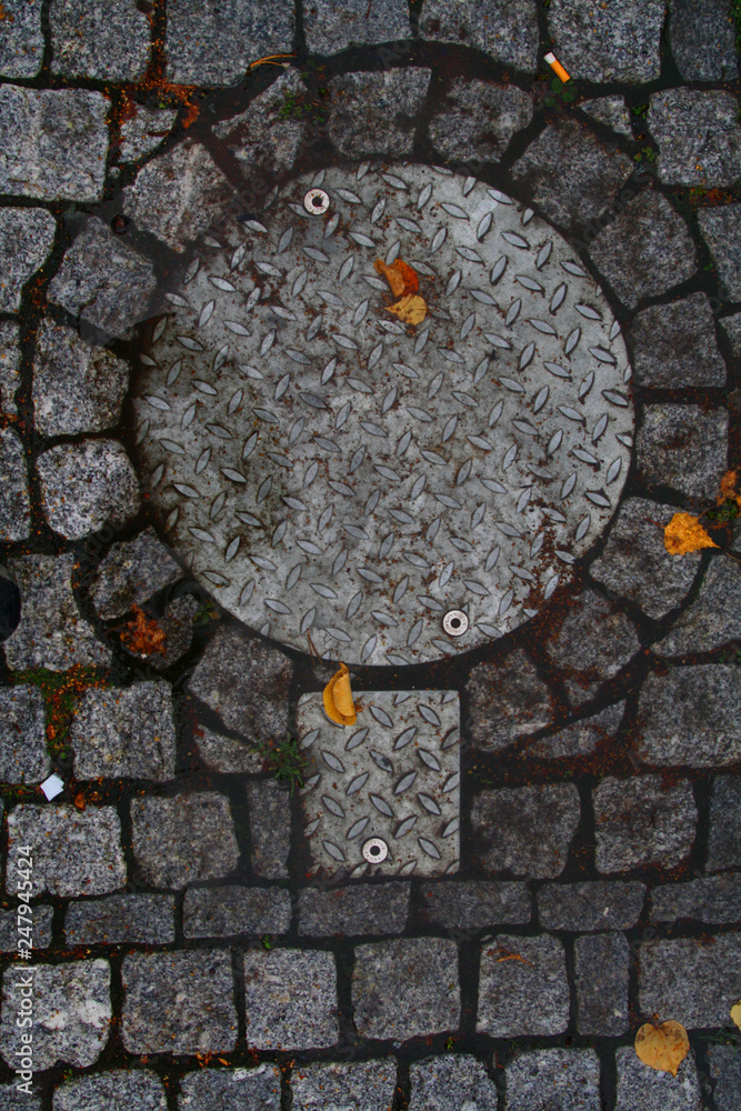 Scandinavian manhole in its urban surrounding. Hidden beauty in design ...