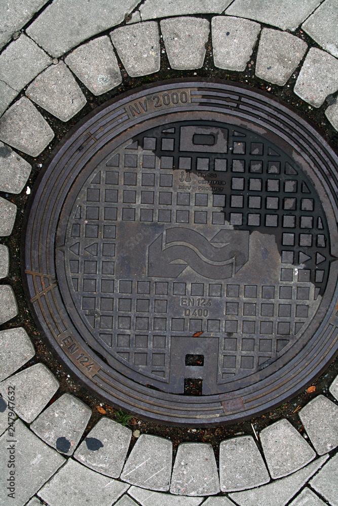 Scandinavian manhole in its urban surrounding. Hidden beauty in design ...