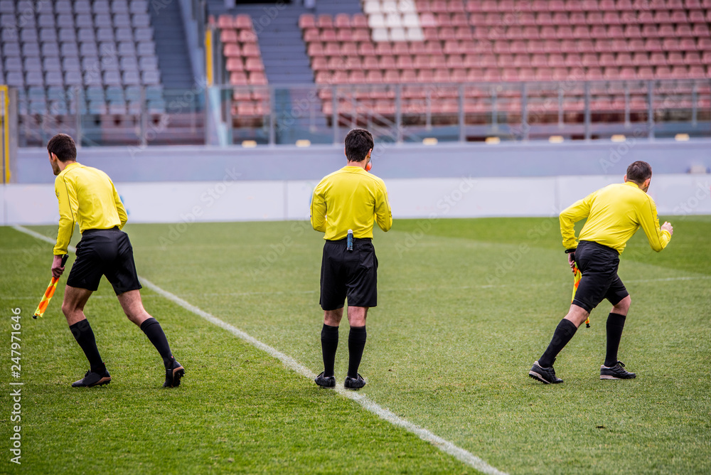 Tree referees at soccer stadium before football match Stock Photo ...