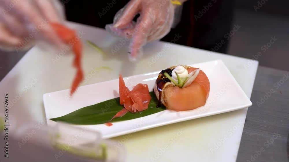 Close scene of working process. Chef is making a presentation of dish ...