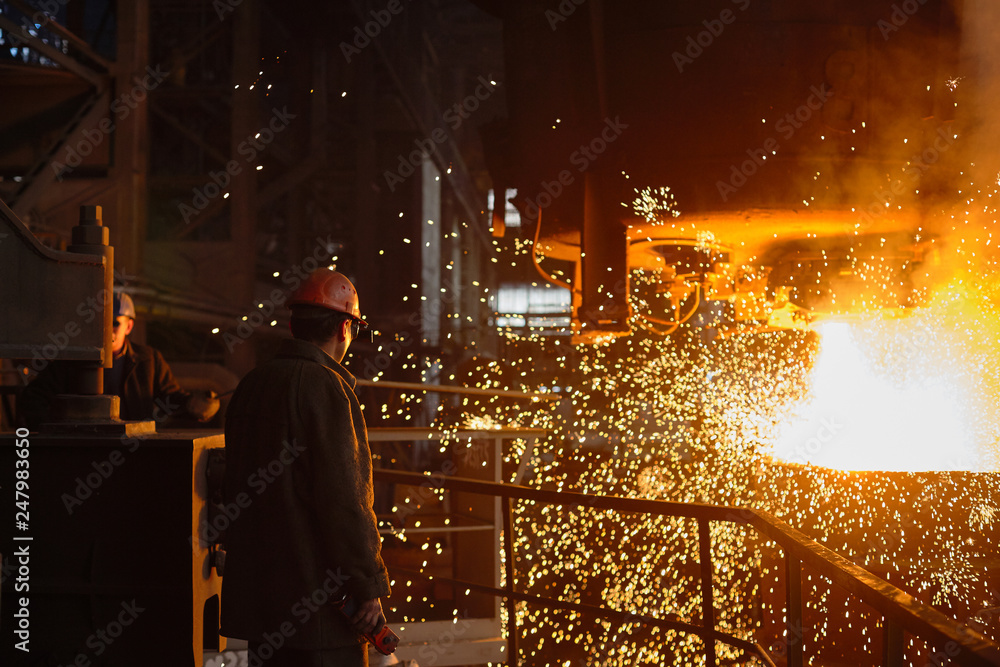 Steelmaker at ingot casting. Electric arc furnace shop EAF ...