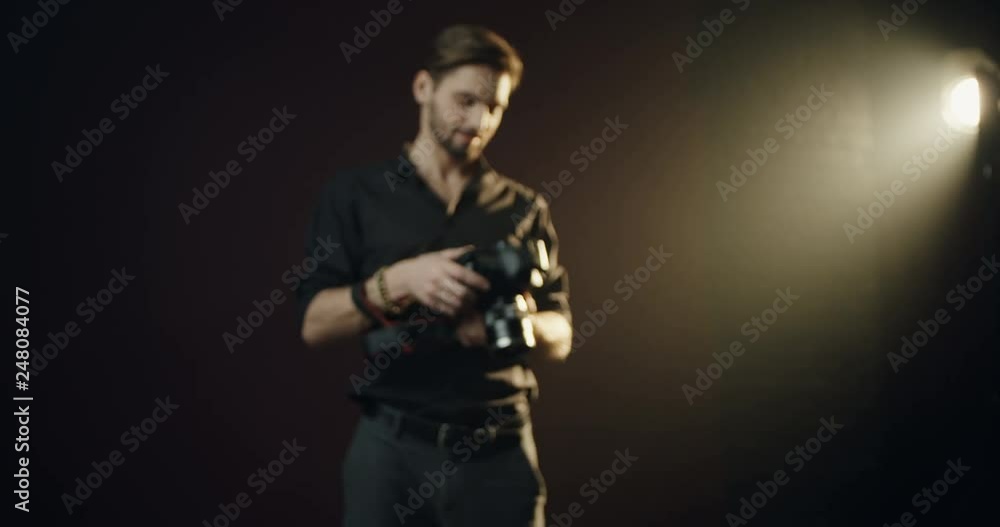 Camera zooming in and taking in focus young Caucasian handsome man ...