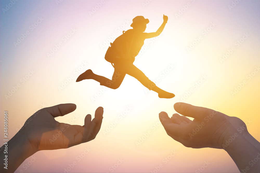 Silhouette girl with the leap in the hand through difficulties, and ...