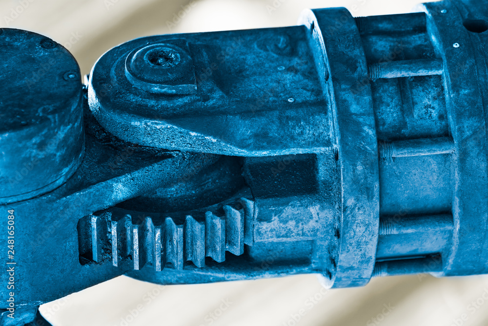 Hydraulic system detail with a gear wheel segment. Metal part of a ...