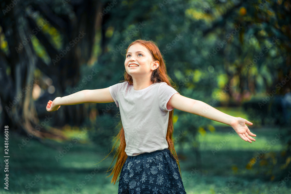 Happy cute little girl playing in the outdoor park in summer. Child ...