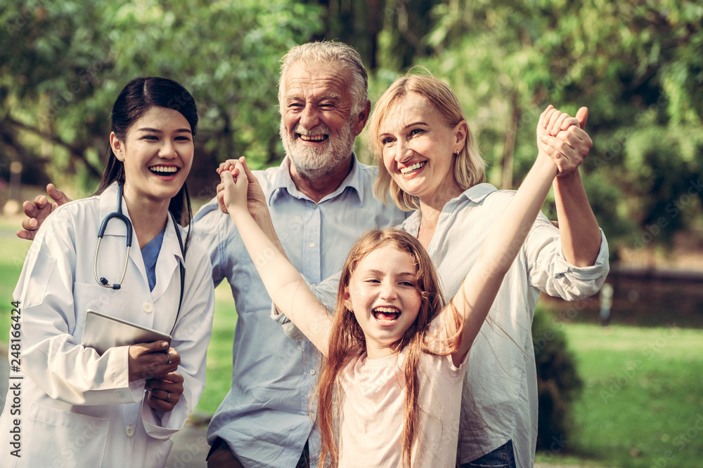 Happy healthy family and doctor talking in the park. People healthcare ...